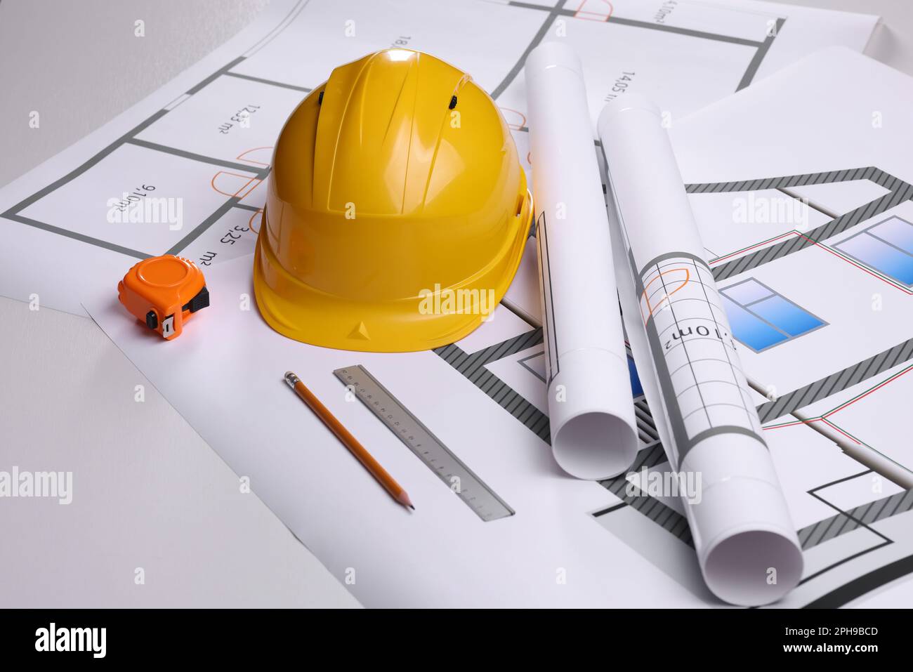 Construction drawings, safety hat, tape measure, pencil and ruler on ...