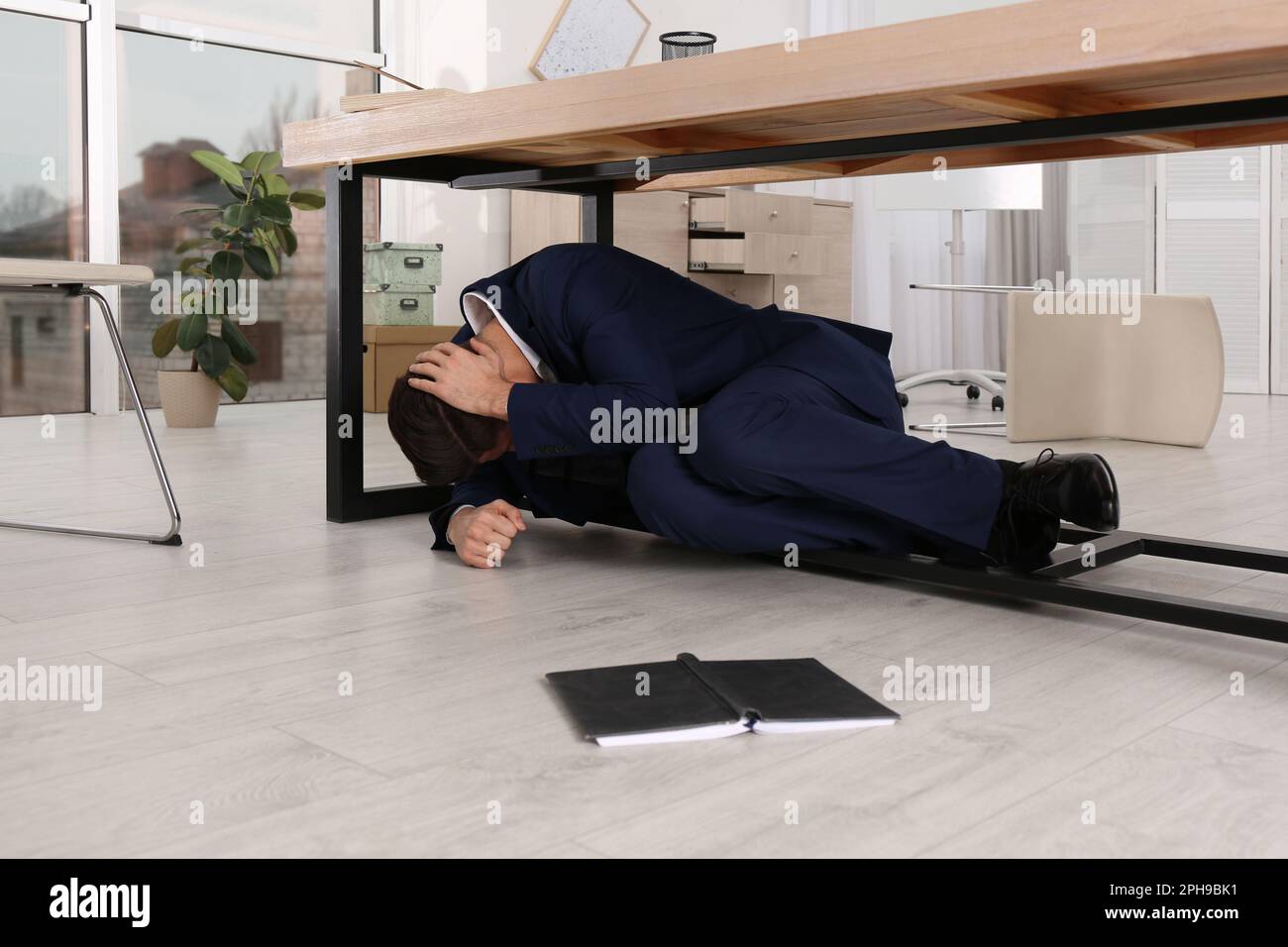 Man Hiding Under Desk Premium Photo | Scared Man Hiding Under Table In