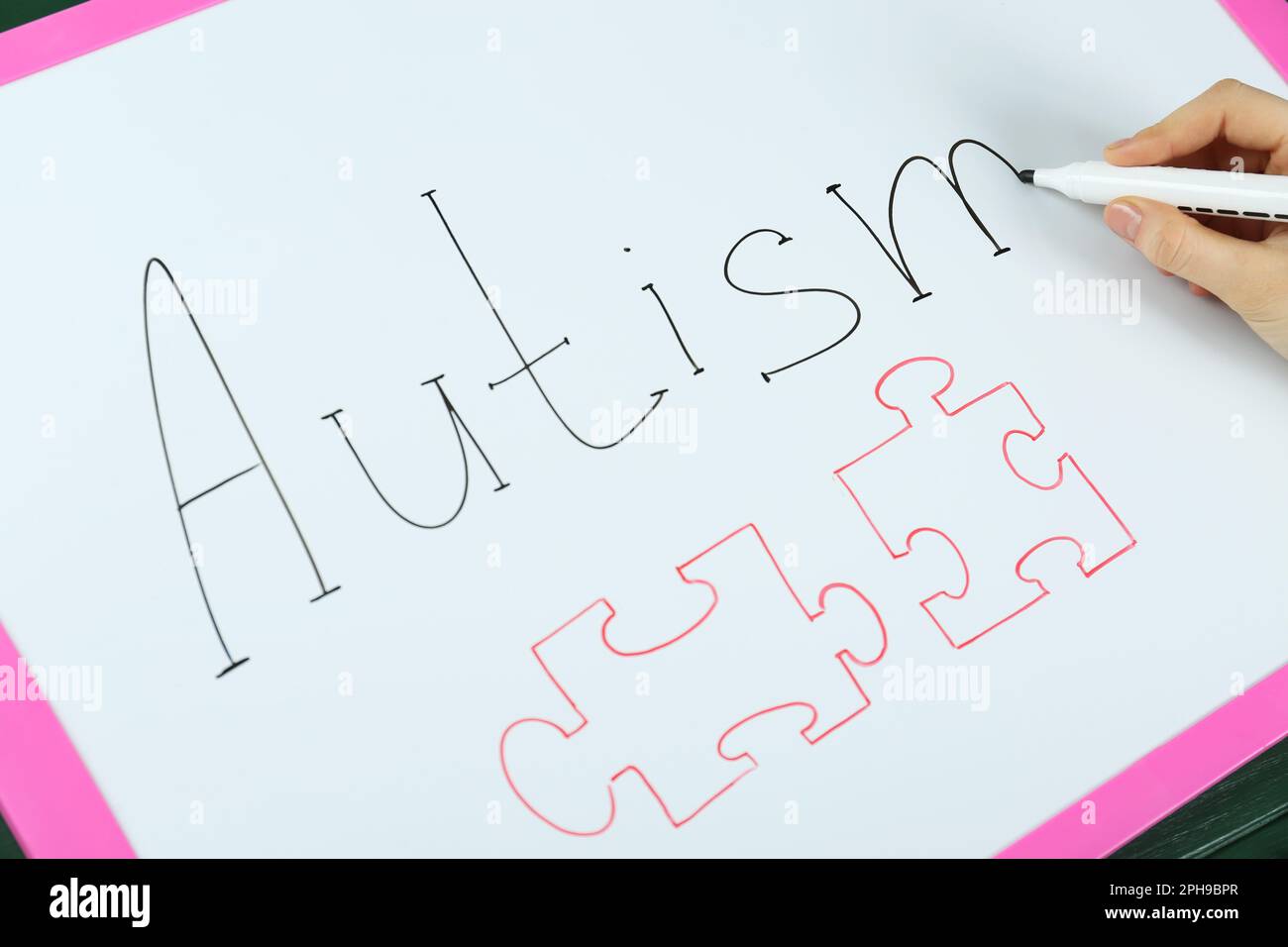 Woman writing word Autism on white board, closeup Stock Photo - Alamy