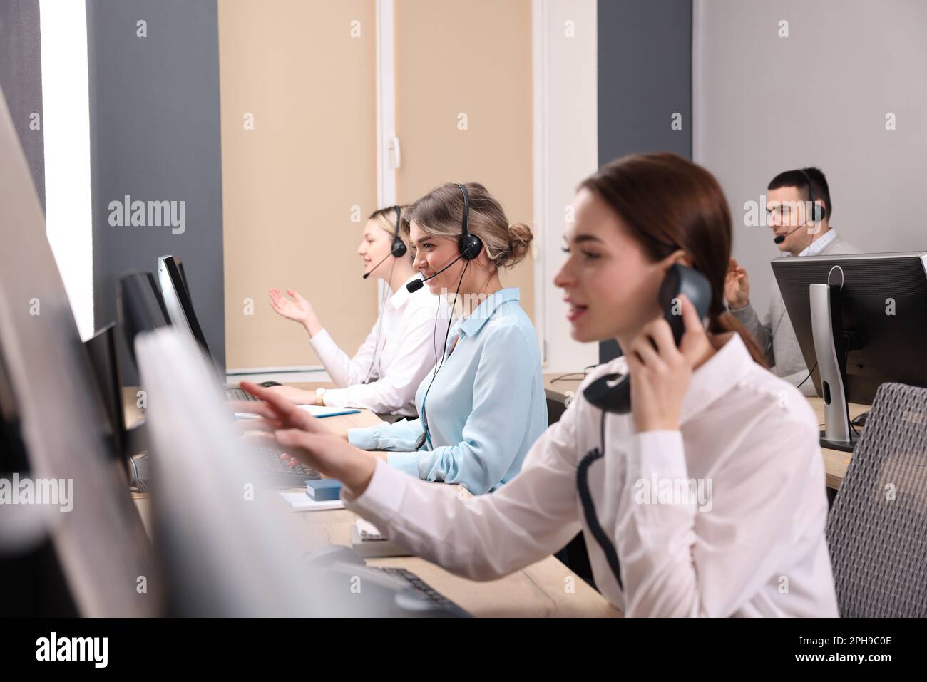 Call center operators working in modern office Stock Photo - Alamy