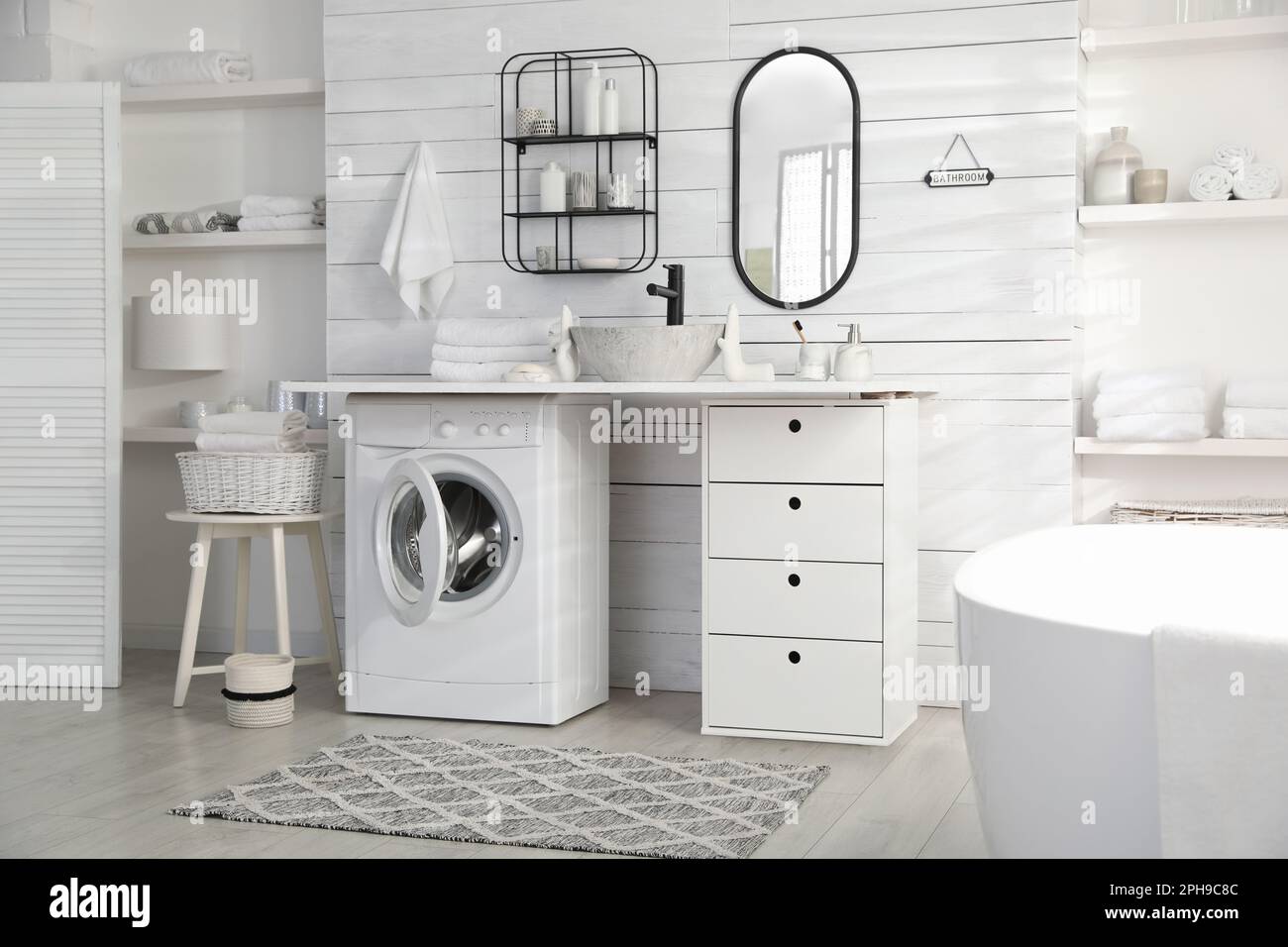 Stylish bathroom interior with modern washing machine Stock Photo - Alamy