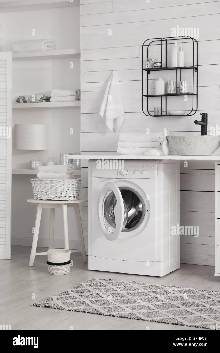 Stylish bathroom interior with modern washing machine Stock Photo - Alamy