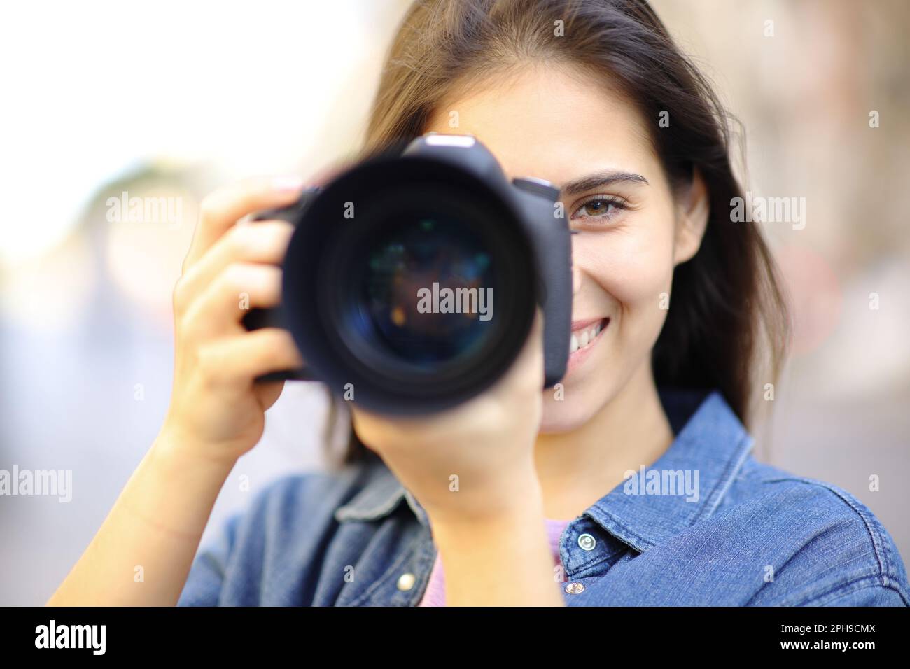 Front view portrait of a happy photographer taking photo of you Stock ...