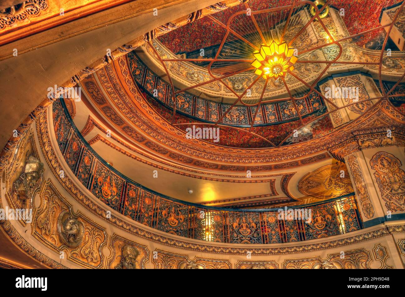 An artistic ceiling of a building featuring a colorful mural, with a ...