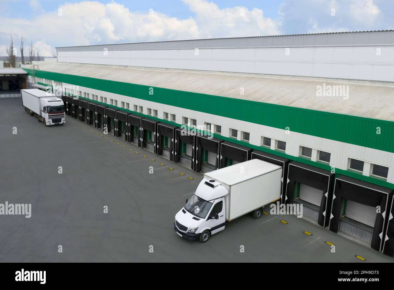 Trucks near big warehouse outdoors, aerial view. Logistics center Stock ...