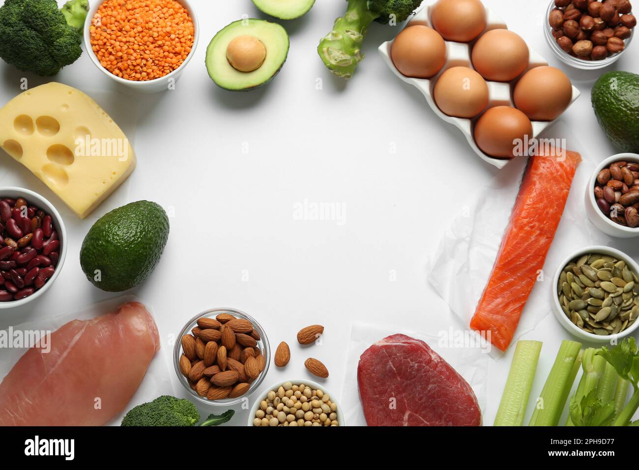 Frame of products rich in amino acids on white background, flat lay ...