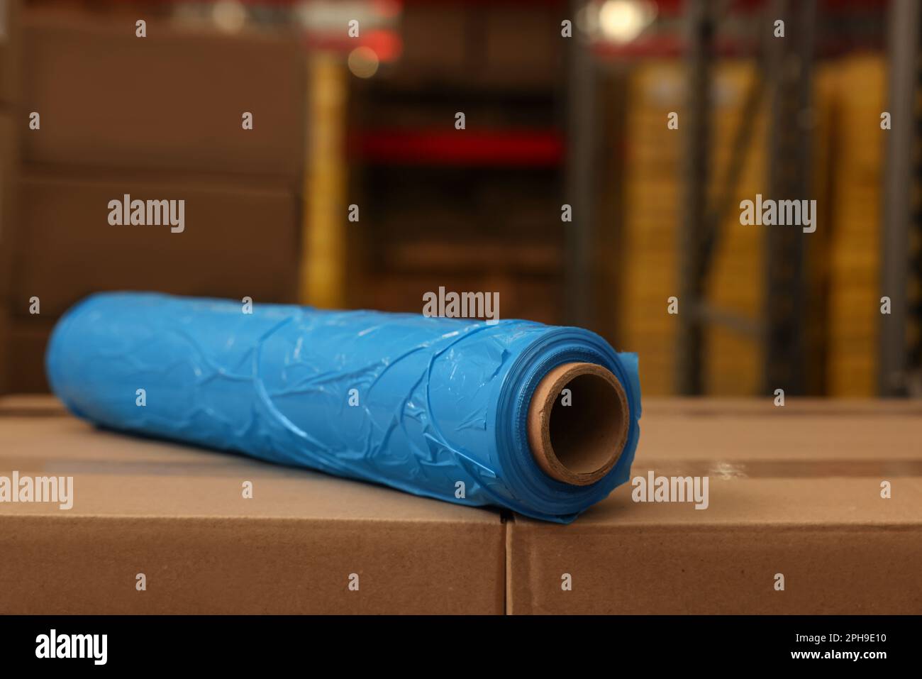 Roll of stretch wrap on boxes in warehouse Stock Photo - Alamy