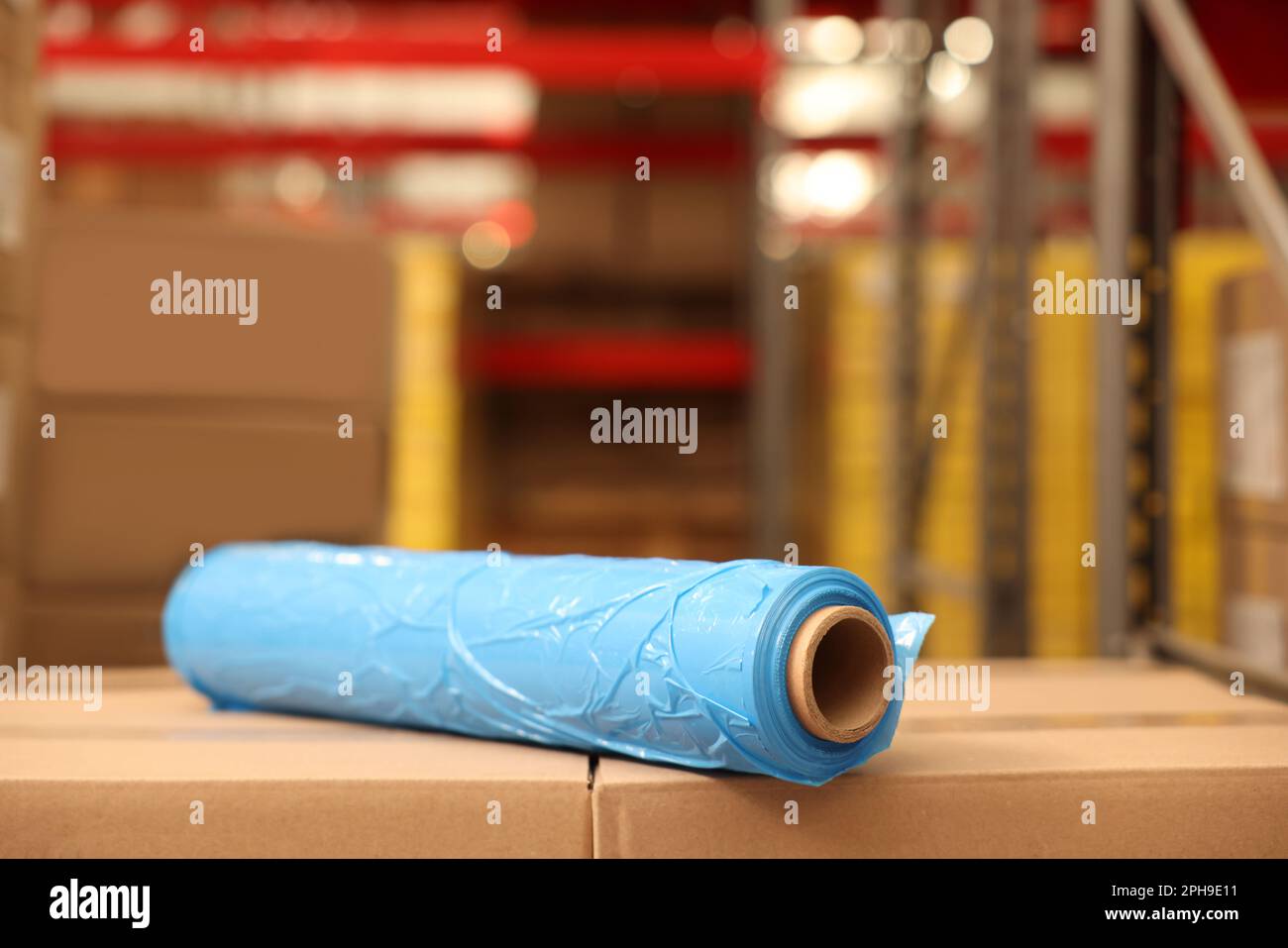 Roll of stretch wrap on boxes in warehouse Stock Photo - Alamy