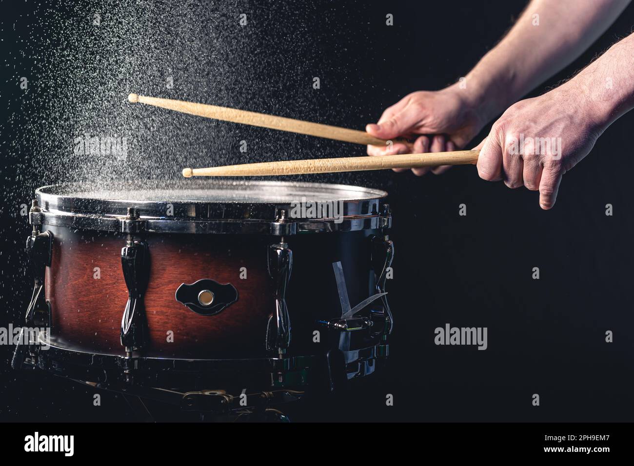 Drummer using drum sticks hitting snare drum with splashing water Stock ...
