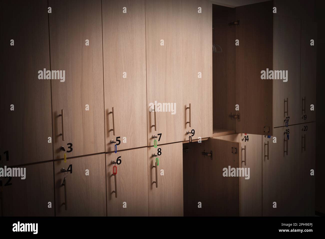 Many wooden lockers with keys and numbers on doors. Vignette effect ...