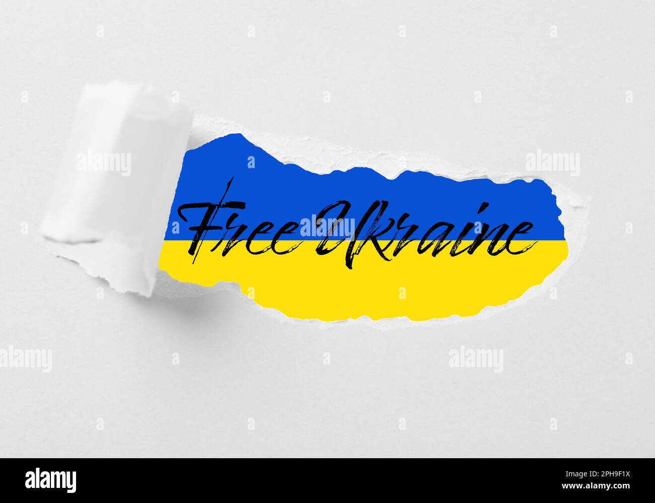 Free Ukraine. Ukrainian flag with phrase, view through torn white paper ...