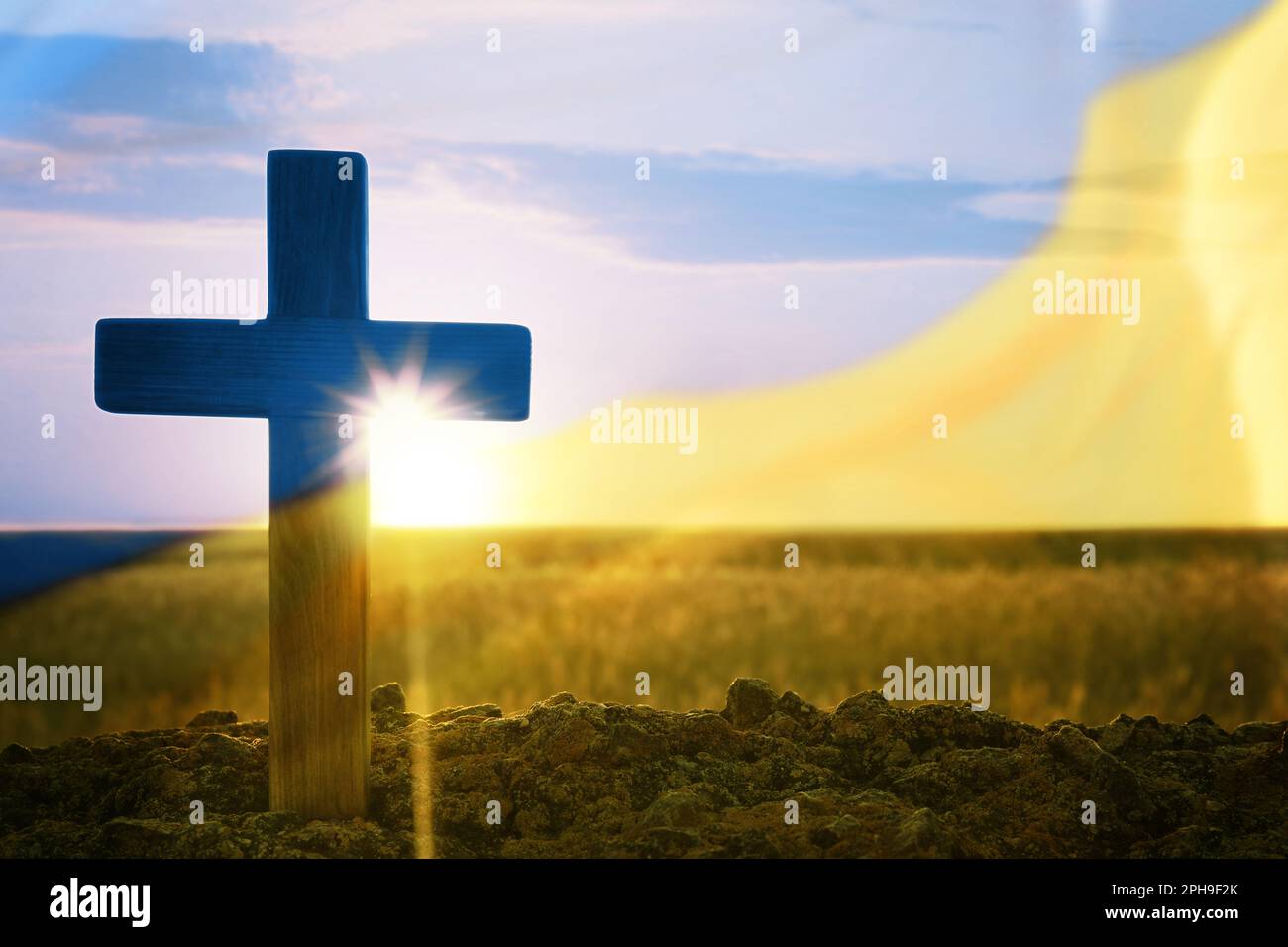 Pray for Ukraine. Double exposure of cross outdoors and Ukrainian flag ...