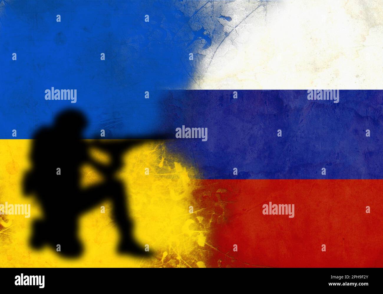 Silhouette of soldier on wall painted in Ukrainian and Russian flags ...