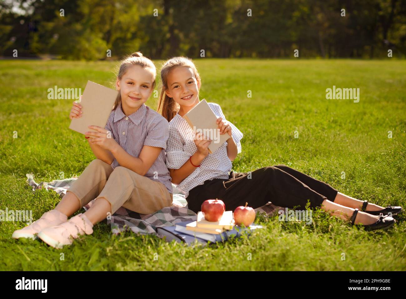 girls holding eco books in hands. cover book mockup. two excited girls ...