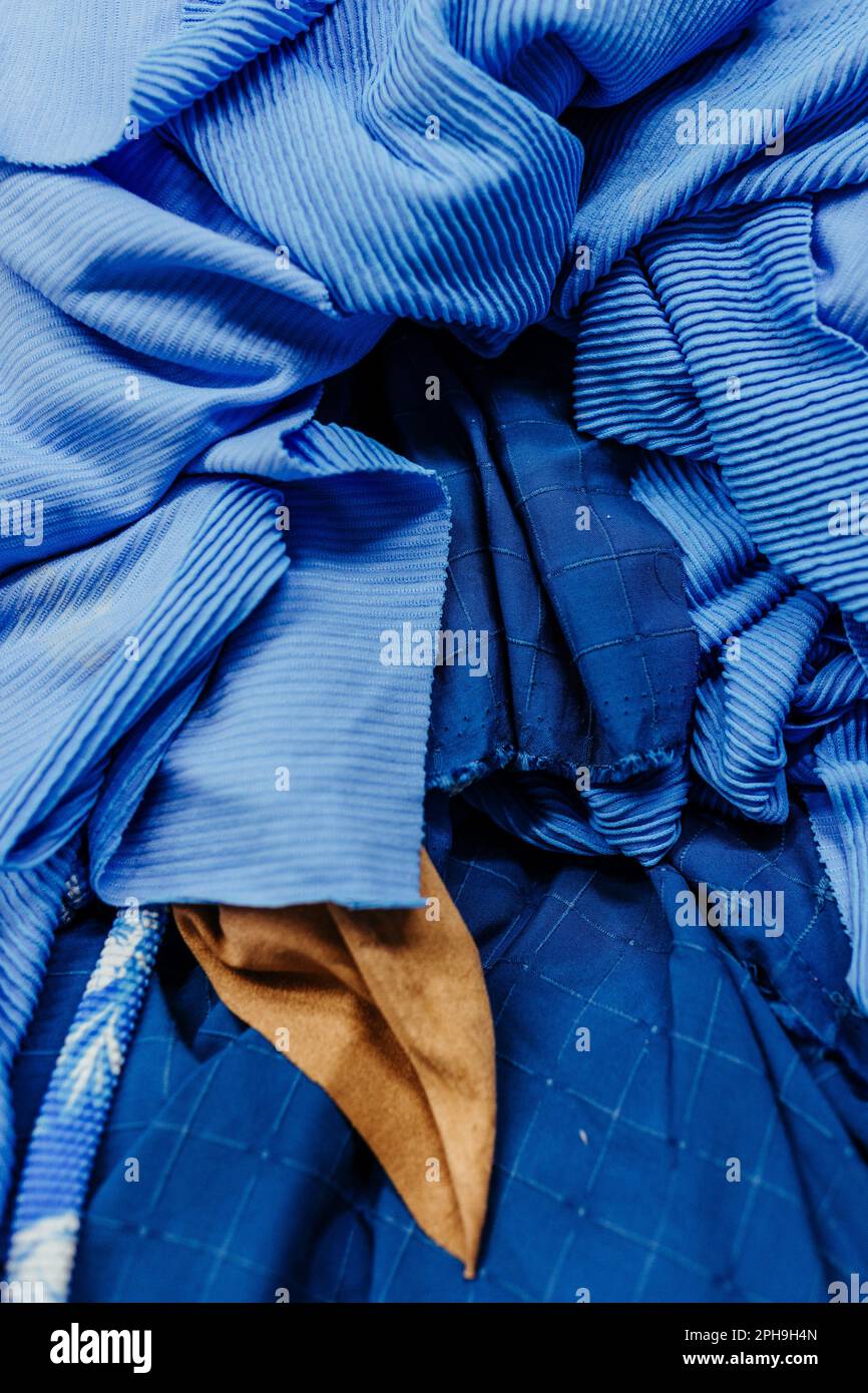 An image of a vertical composition of blue fabrics overlapping each ...