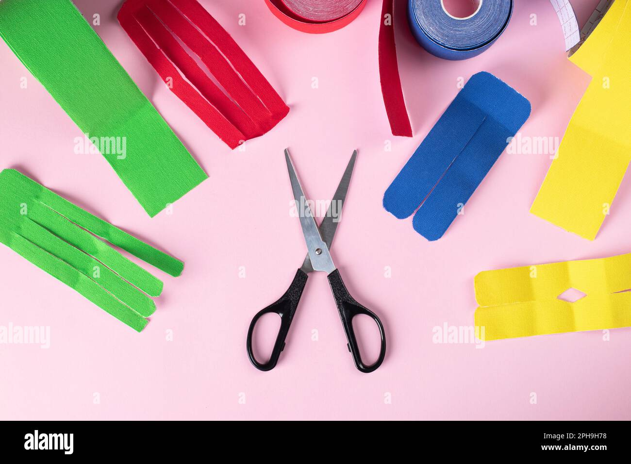Colorful kinesiology tape, scissors and different shape cuts for ...