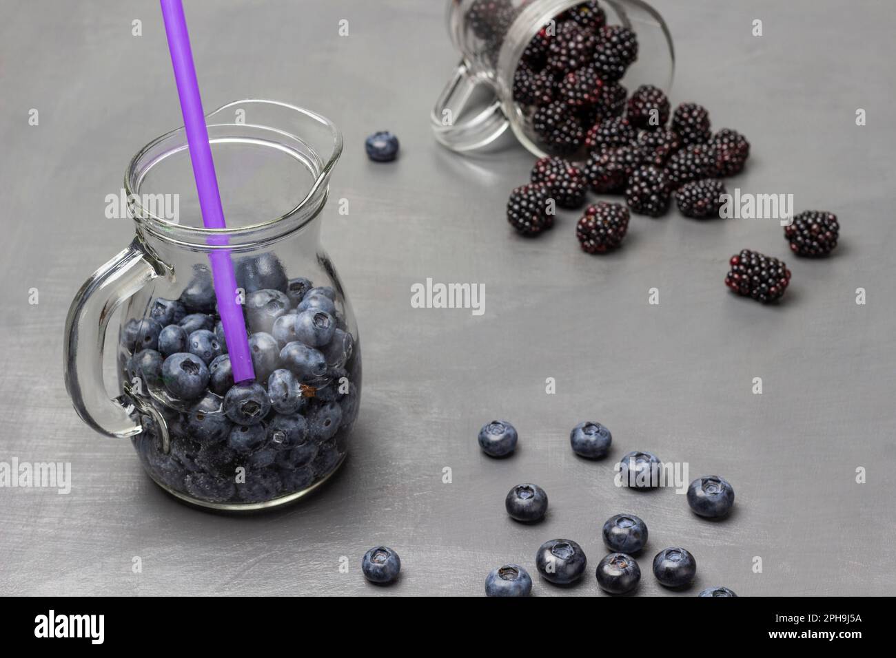 Berry summer drink made from berries and a straw in a decanter ...