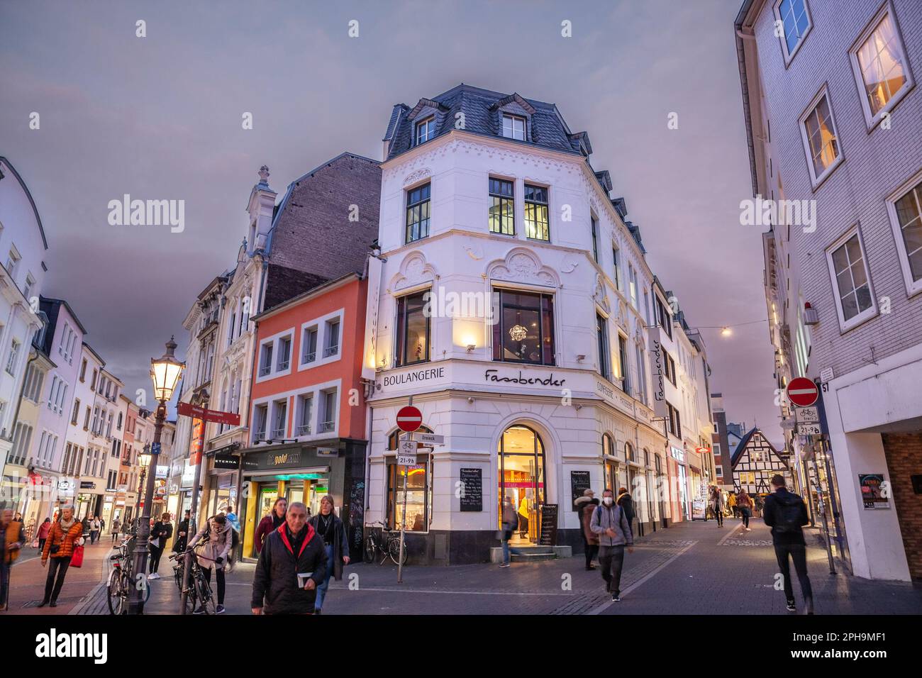 Picture of facades of a medieval street at dusk, with shops and ...