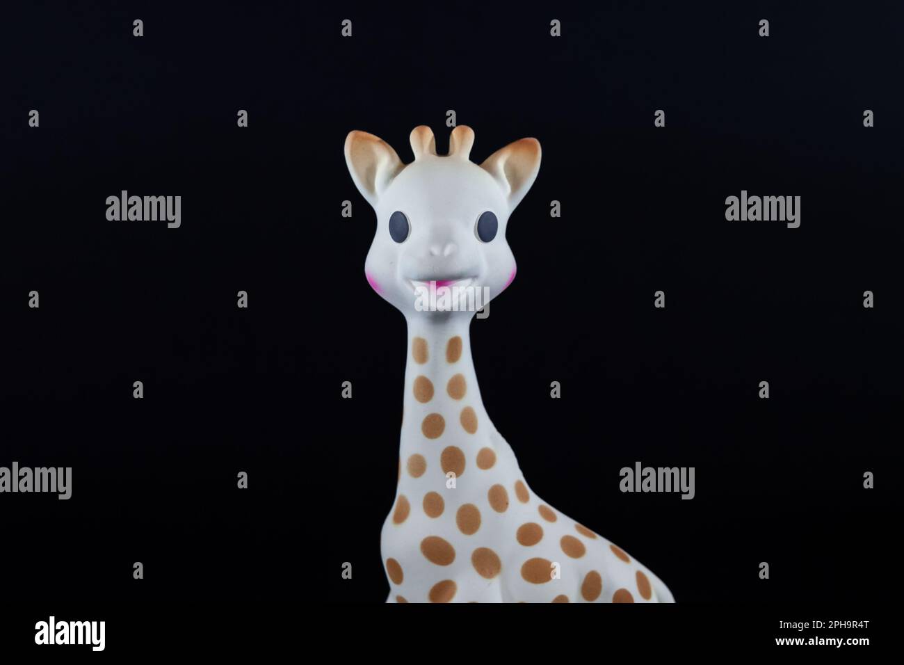 Picture of a Sophie la Girafe toy on a black background. Sophie the ...