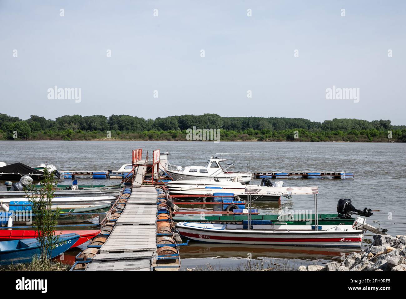 Picture of boats of various sizes on Danube river anchored on a pier, a ...