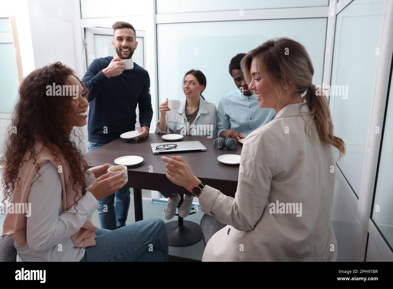 Team of employees enjoying coffee break together in office. Startup ...