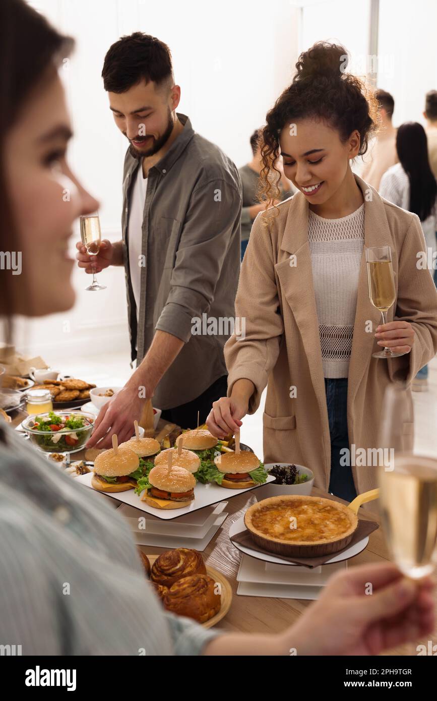 Group of people enjoying brunch buffet together indoors Stock Photo - Alamy