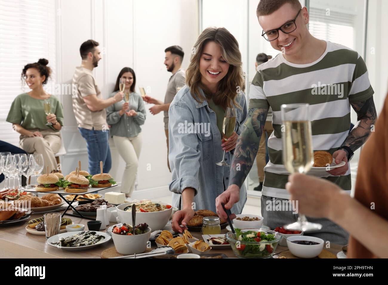 Group of people enjoying brunch buffet together indoors Stock Photo - Alamy