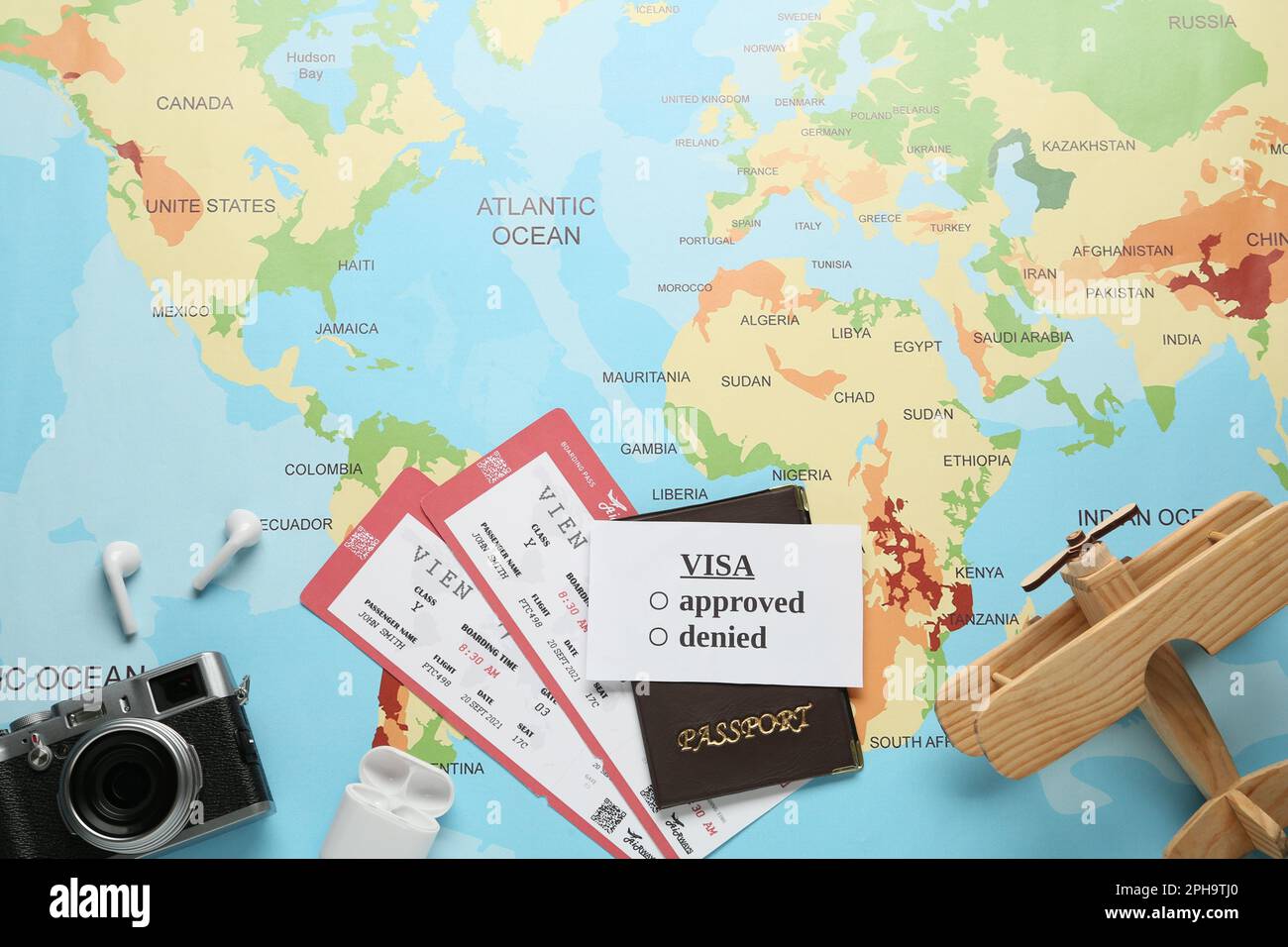 Flat lay composition with passport and tickets on world map. Space for ...