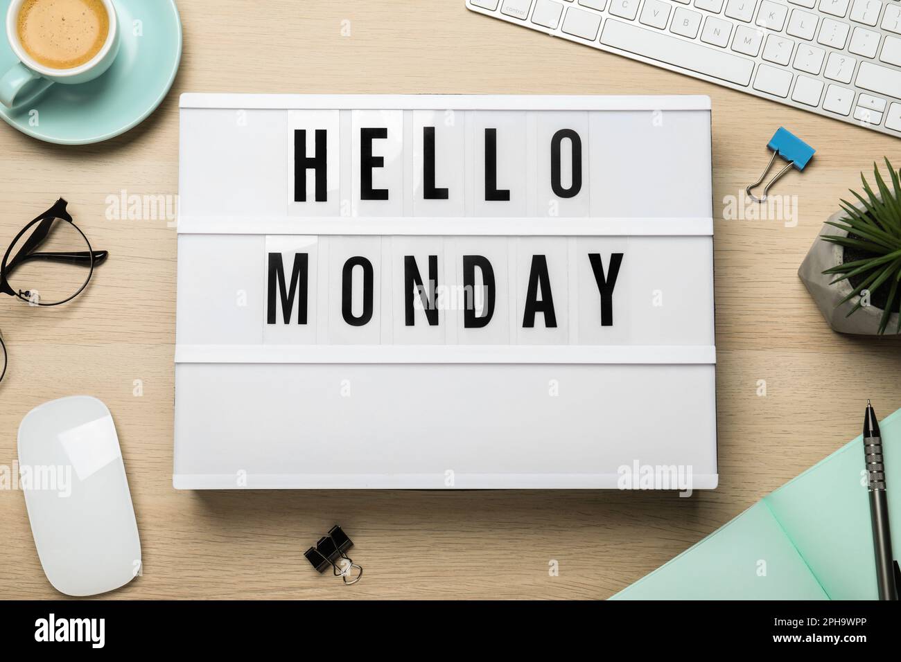 Flat lay composition of lightbox with phrase Hello Monday at workplace ...
