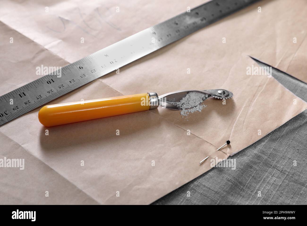 Tracing wheel and ruler with sewing pattern on fabric, closeup Stock ...