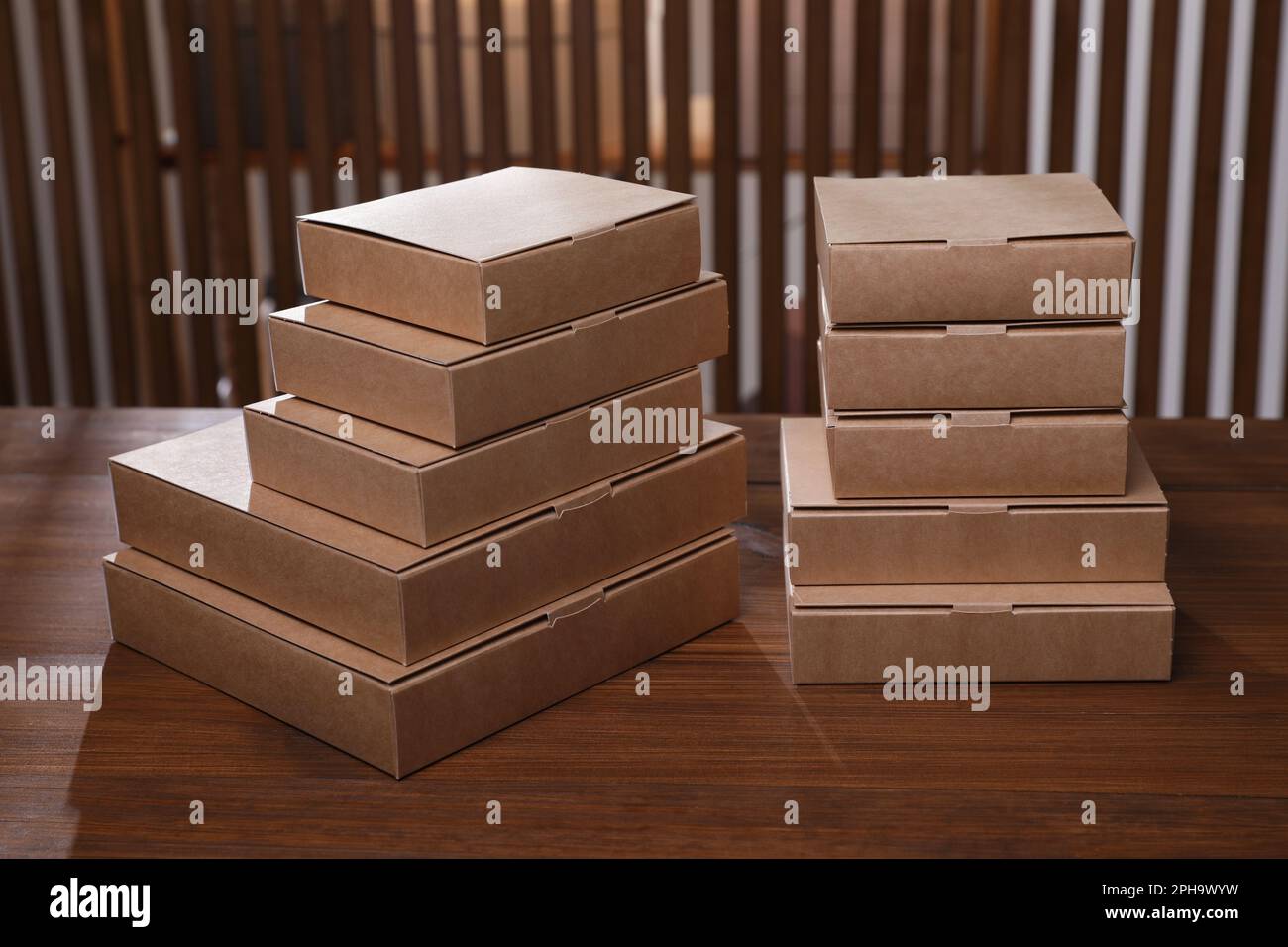Stacked packaging boxes on wooden table indoors. Production line Stock ...