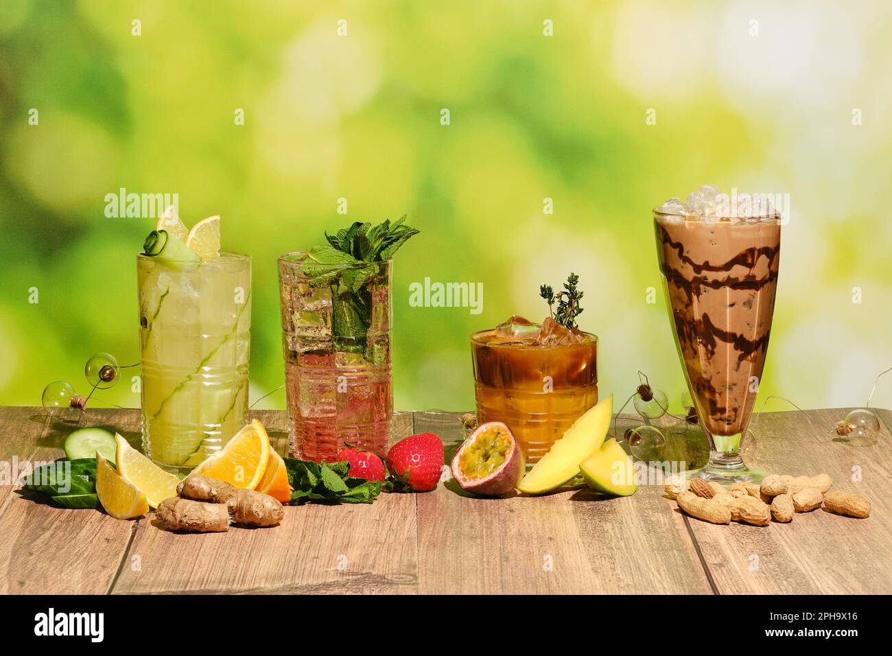 Set of multicolored summer refreshing soft drinks on wooden table with ...