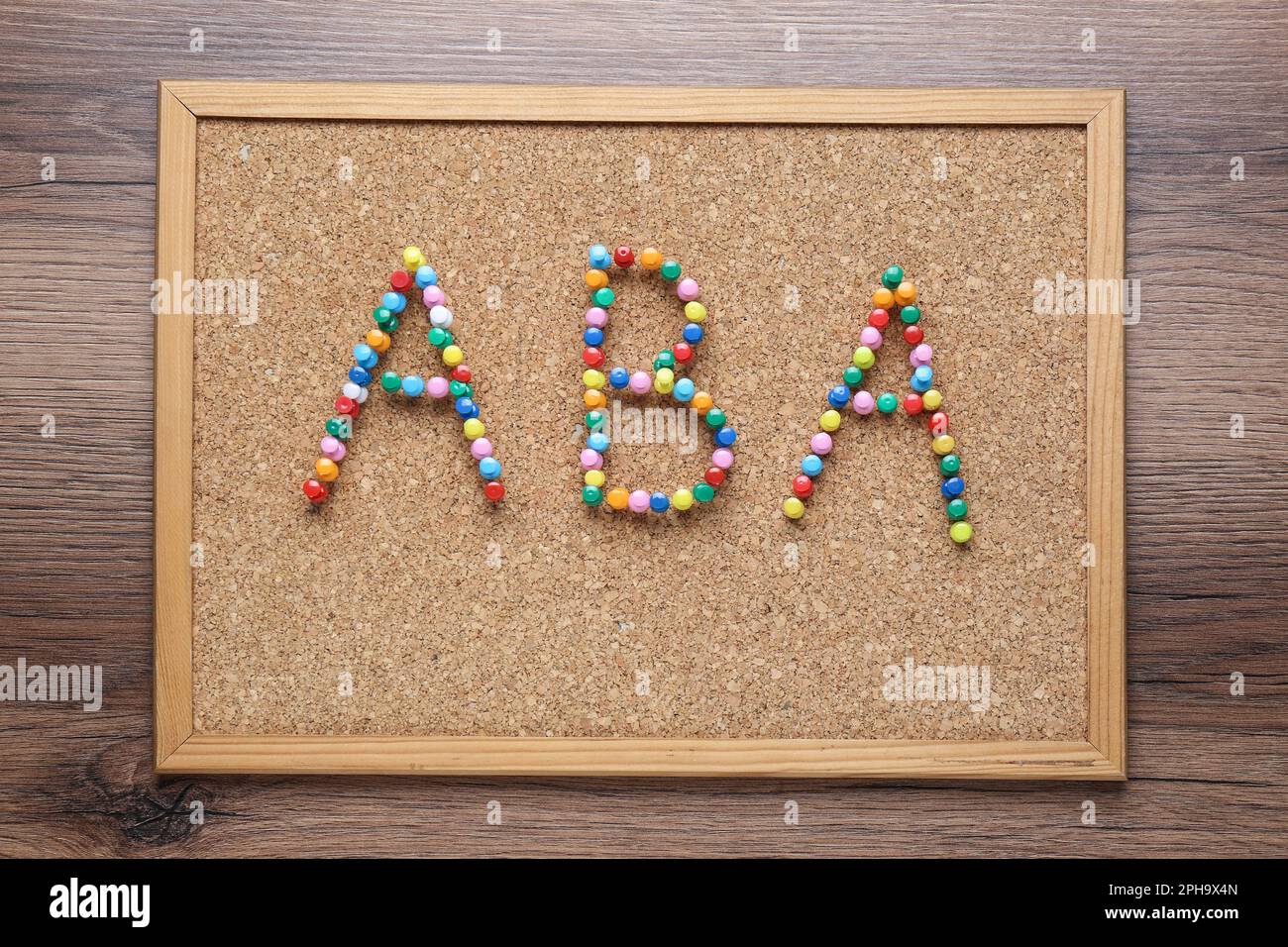 Applied behavior analysis concept. Corkboard with abbreviation ABA made ...