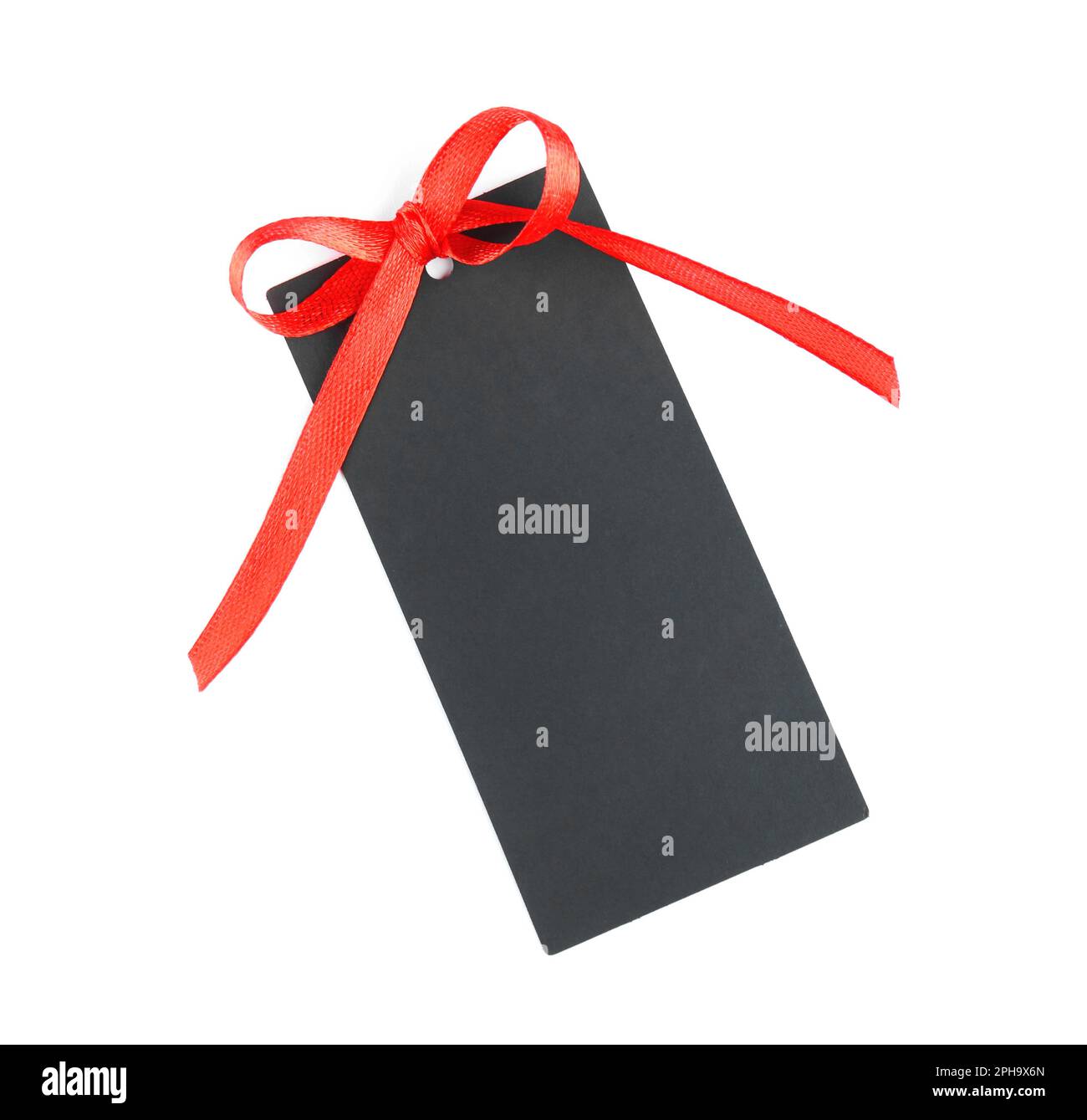 Blank black gift tag with red satin ribbon on white background, top ...
