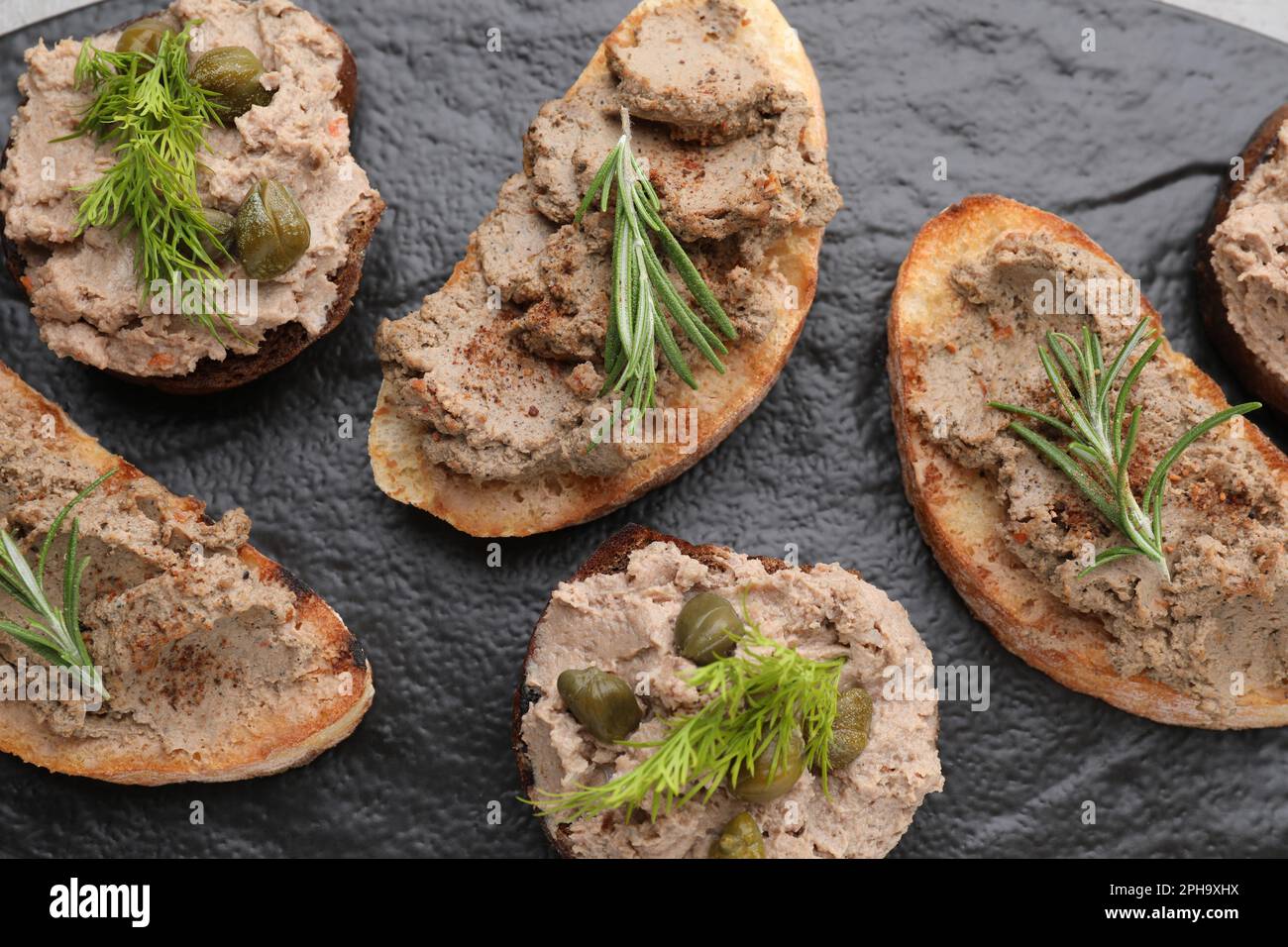 Slices of bread with delicious pate on slate board, flat lay Stock ...