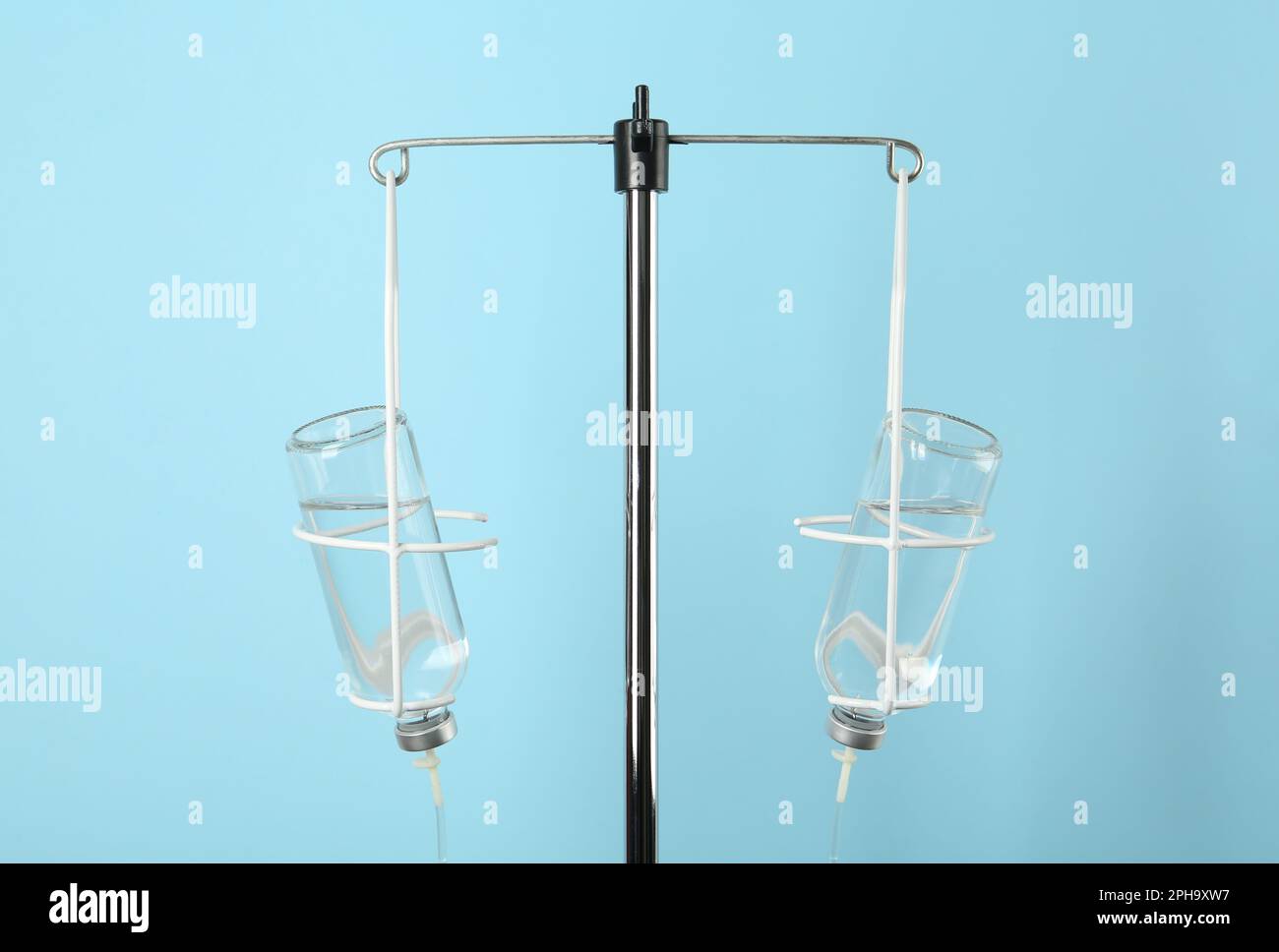 IV infusion set on light blue background Stock Photo - Alamy