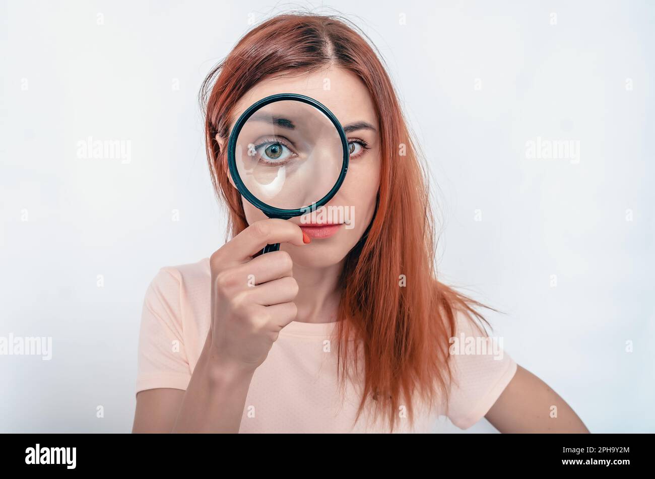 Bad eyesight. Woman's face through magnifying glass. Long hair, big ...