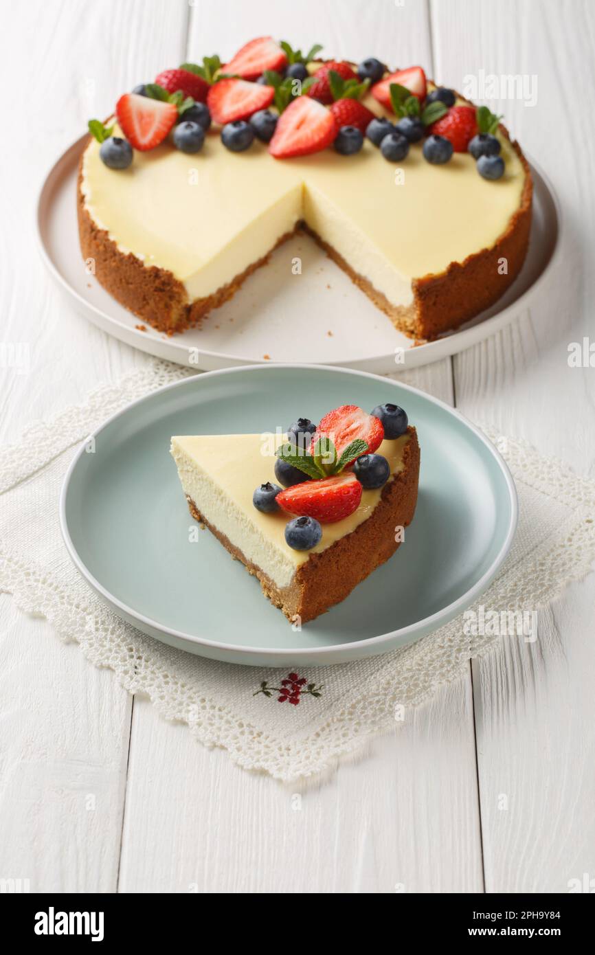 Classic Freshly New York Cheesecake with fresh berries and mint closeup ...