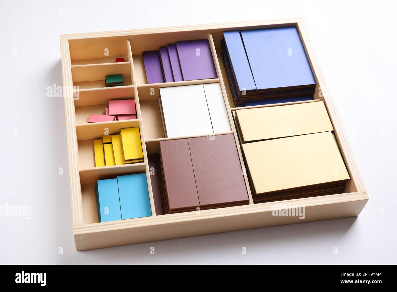 Set of wooden geometrical figures in box isolated on white. Montessori ...