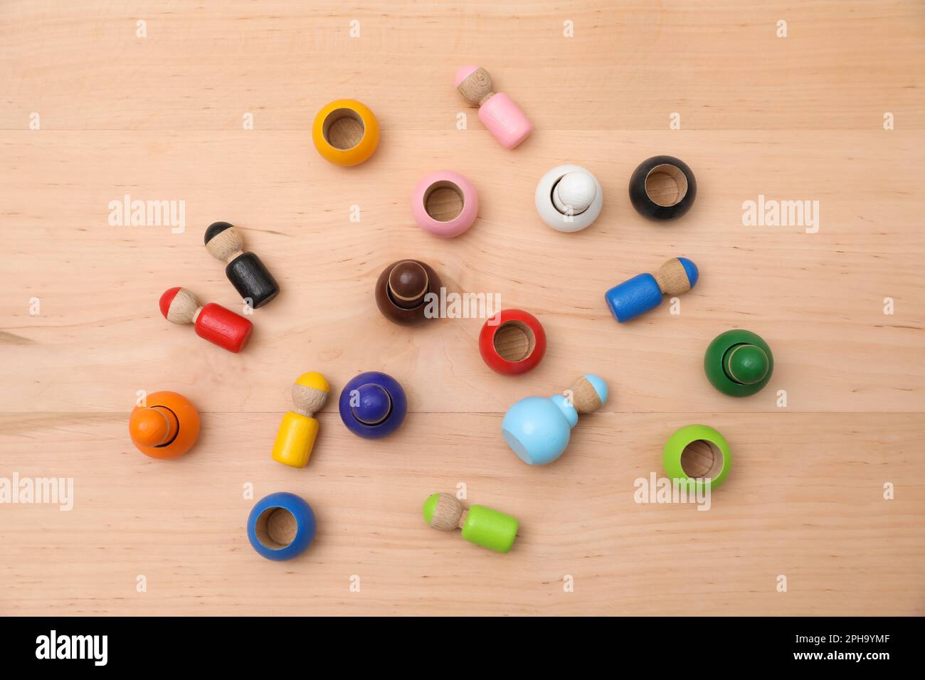 Wooden colorful dolls shaped building blocks on table, flat lay ...