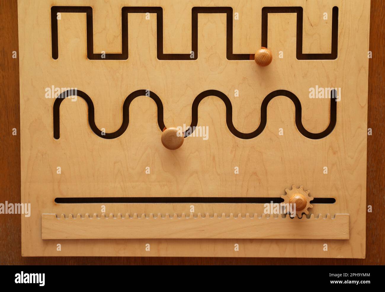 Wooden sliding maze with different lines on table. Montessori toy Stock ...