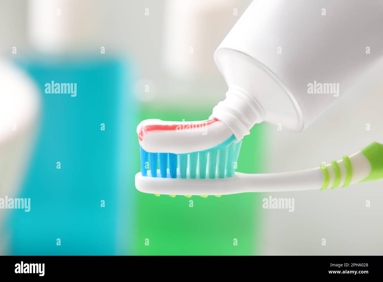 Applying toothpaste on brush against blurred background, closeup Stock ...