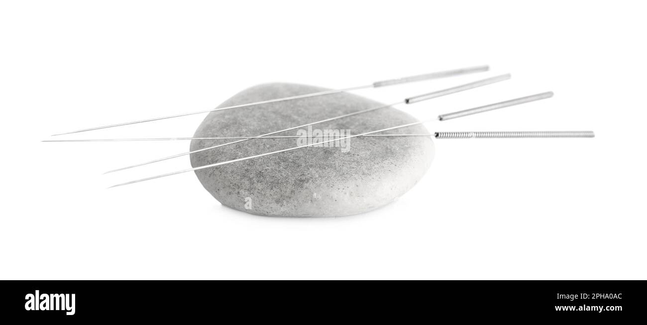 Needles for acupuncture and stone on white background Stock Photo - Alamy
