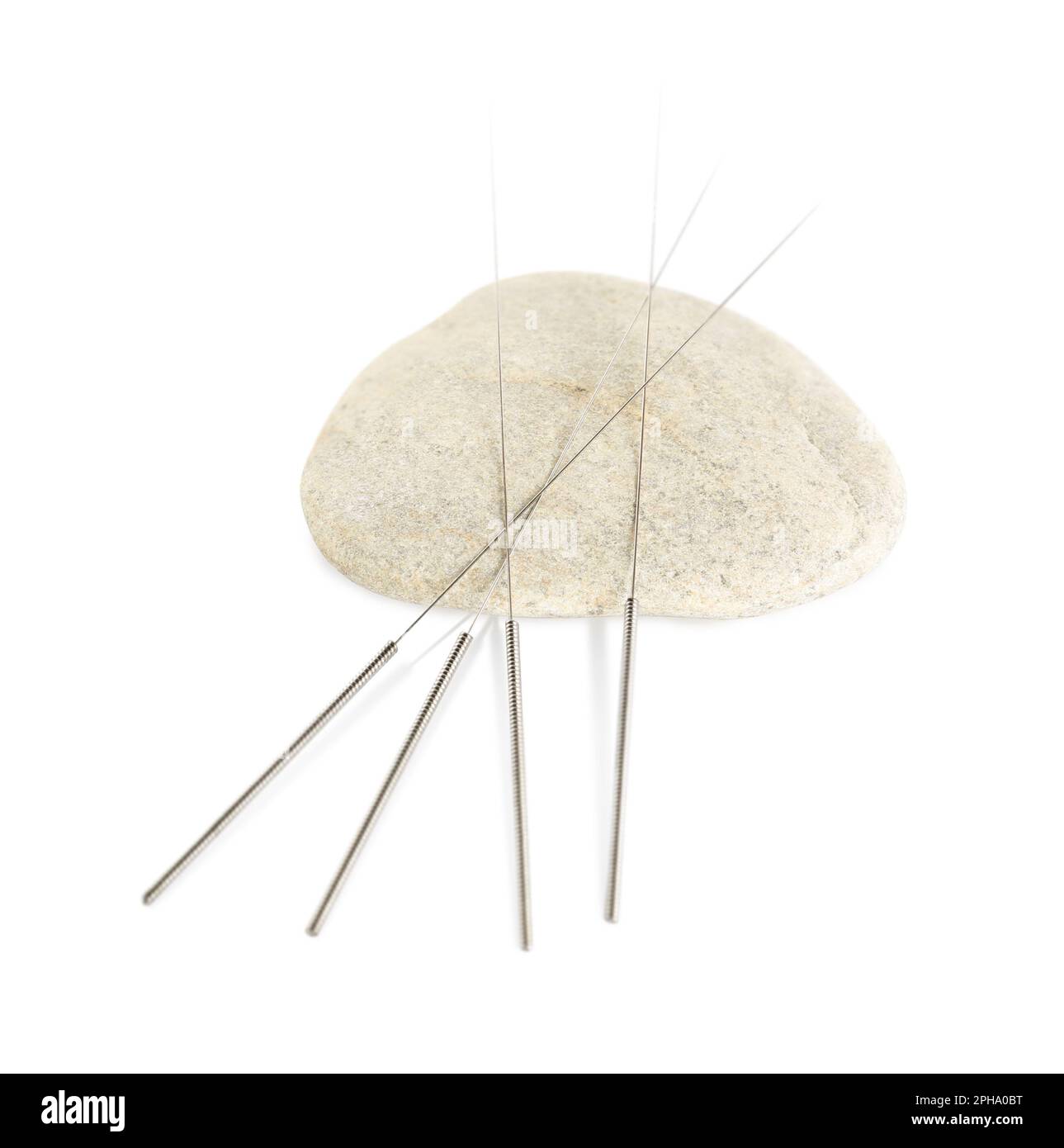 Many needles for acupuncture and stone on white background, top view ...
