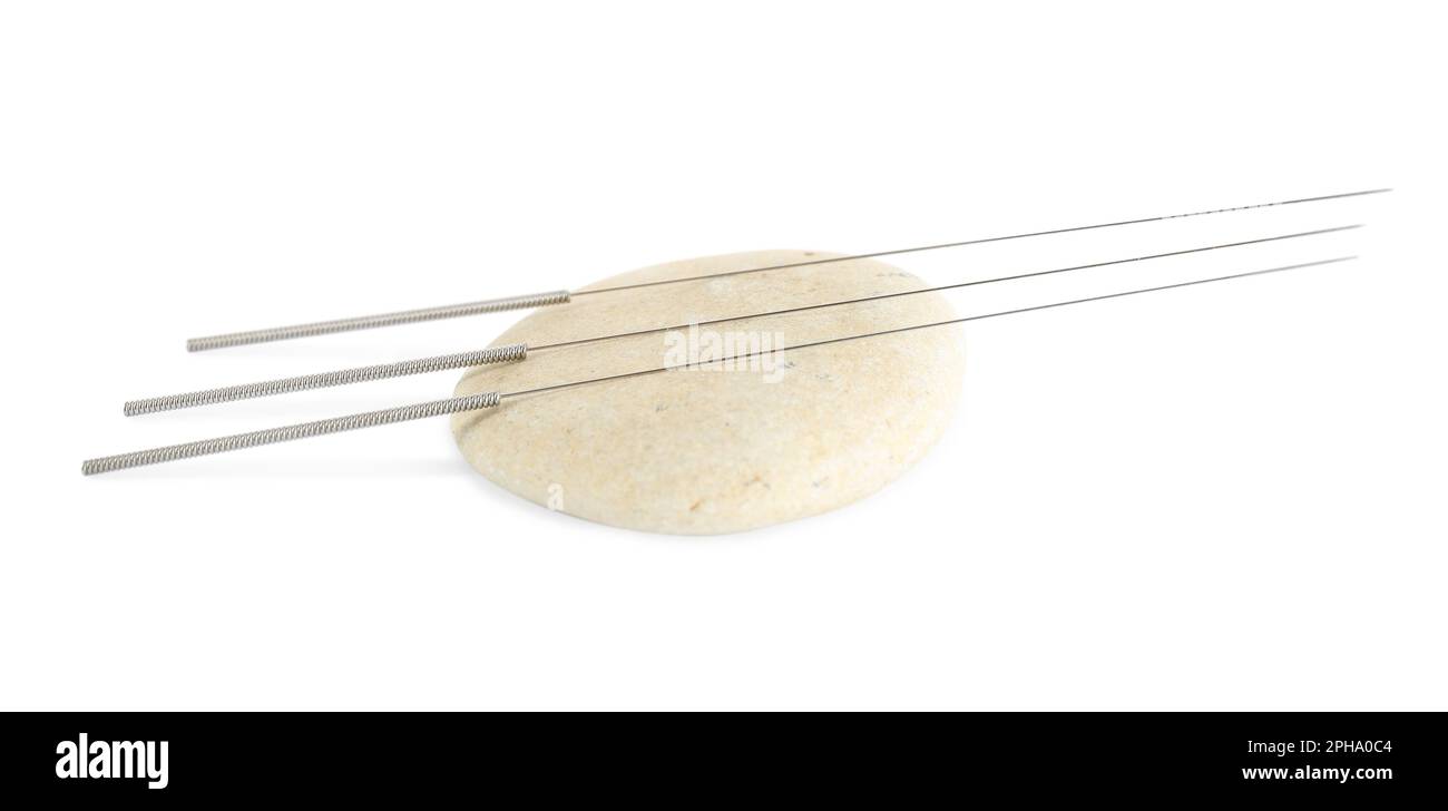 Needles for acupuncture and stone on white background Stock Photo - Alamy