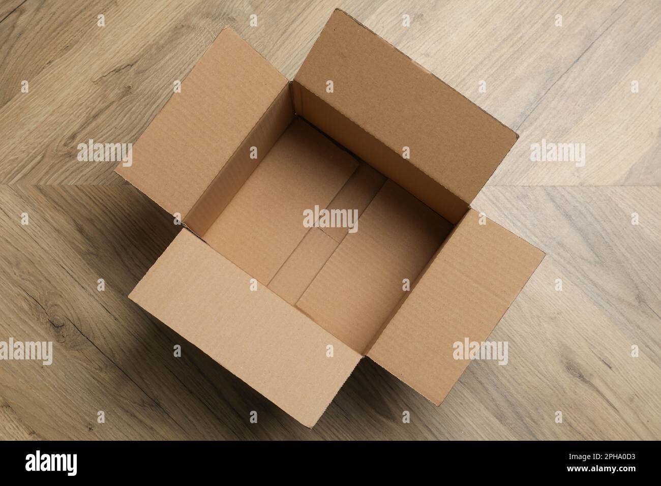 Empty open cardboard box on floor, top view Stock Photo - Alamy
