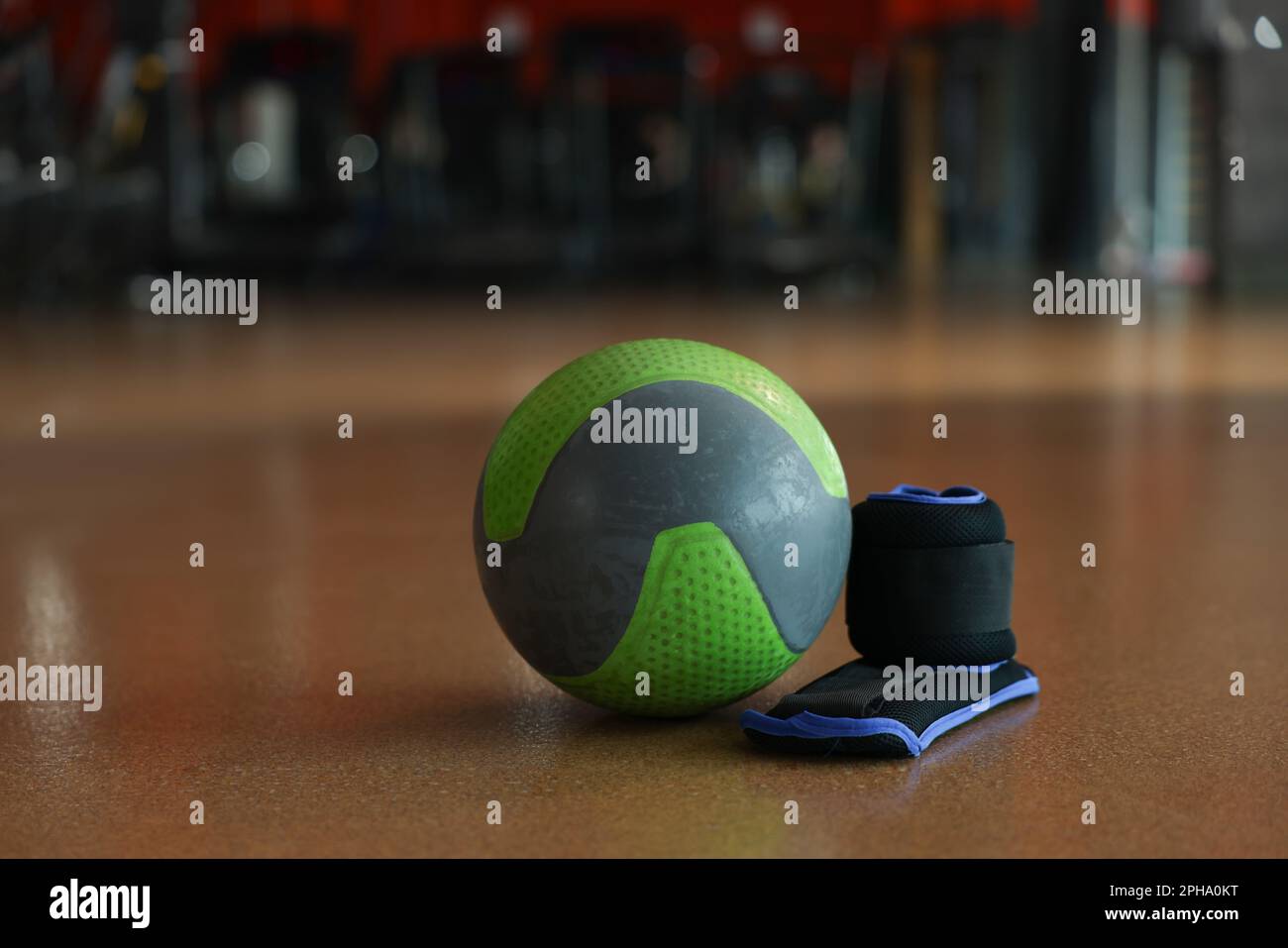 Medicine ball and ankle weights on floor in gym Stock Photo - Alamy