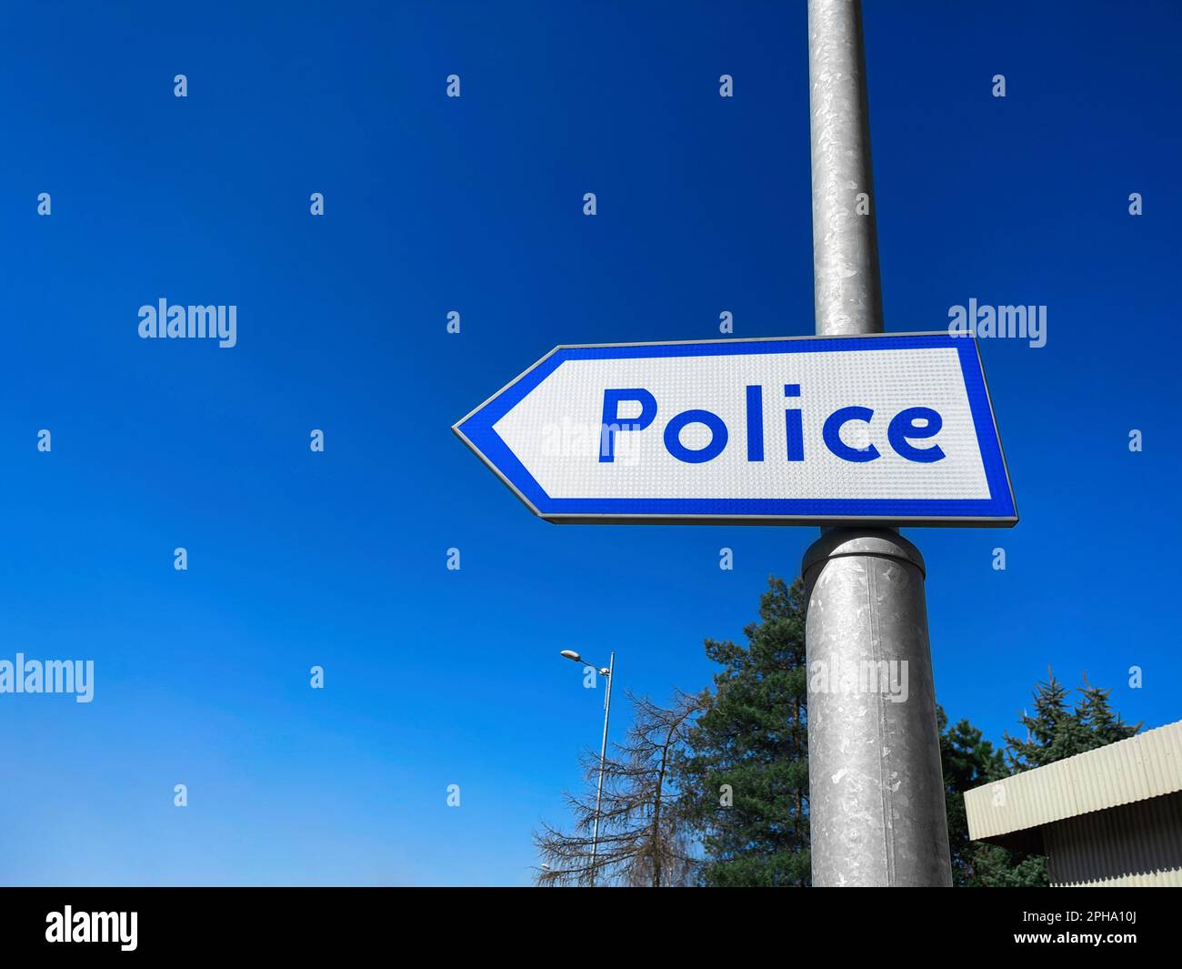 Blue pointer with word Police on pillar outdoors Stock Photo - Alamy
