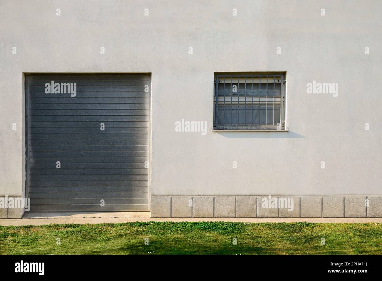 Building exterior with roller shutter door and grated window Stock ...