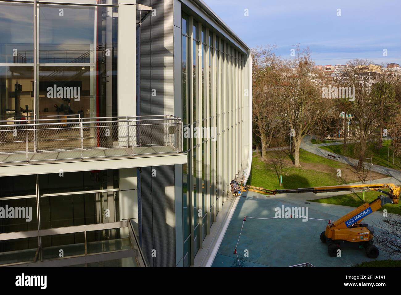 Workers cleaning windows from a self-propelled telescopic boom lift at ...